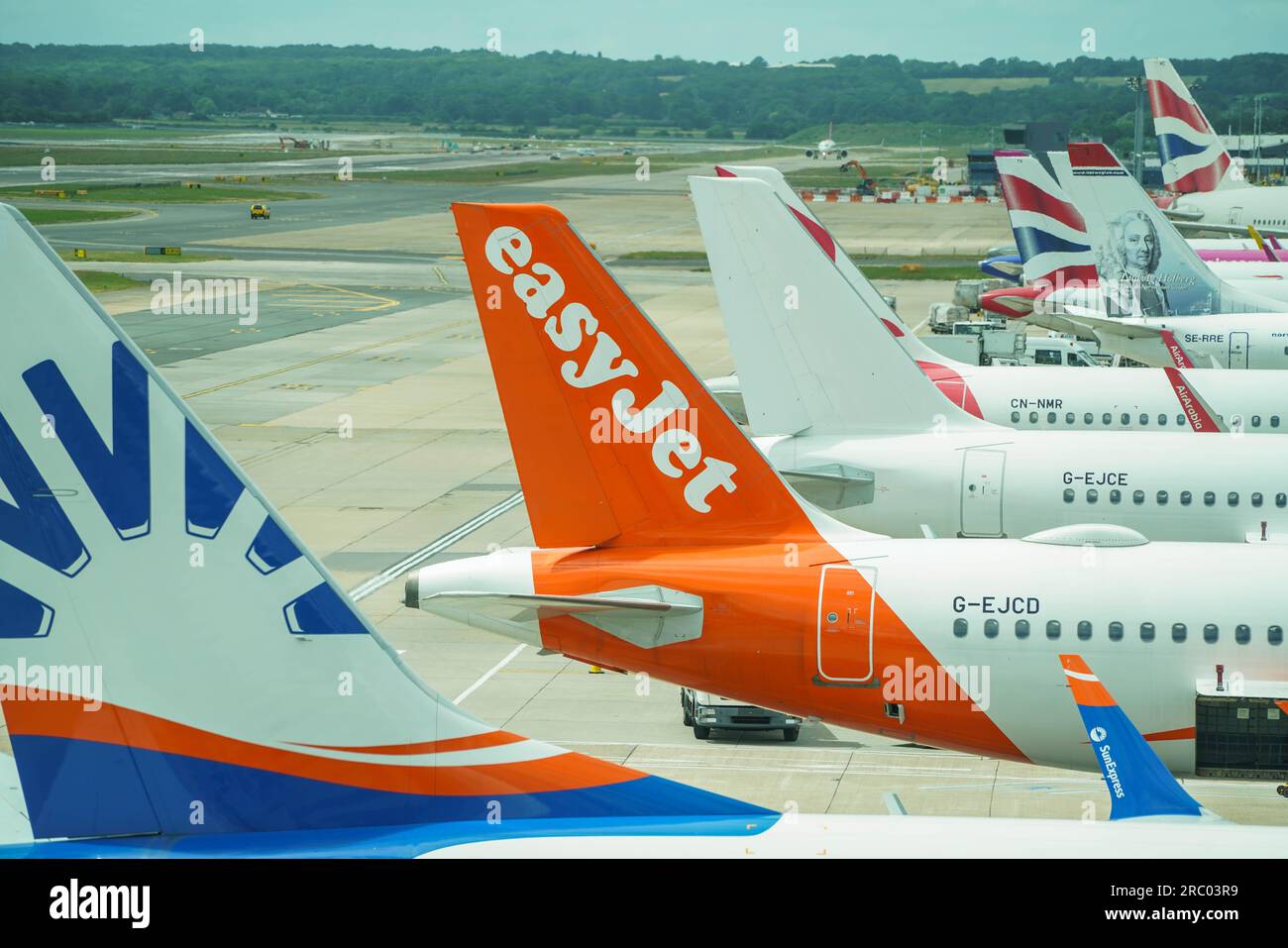 London UK. 11 July 2023 Easyjet aircrafts parked at a gate at Gatwick ...