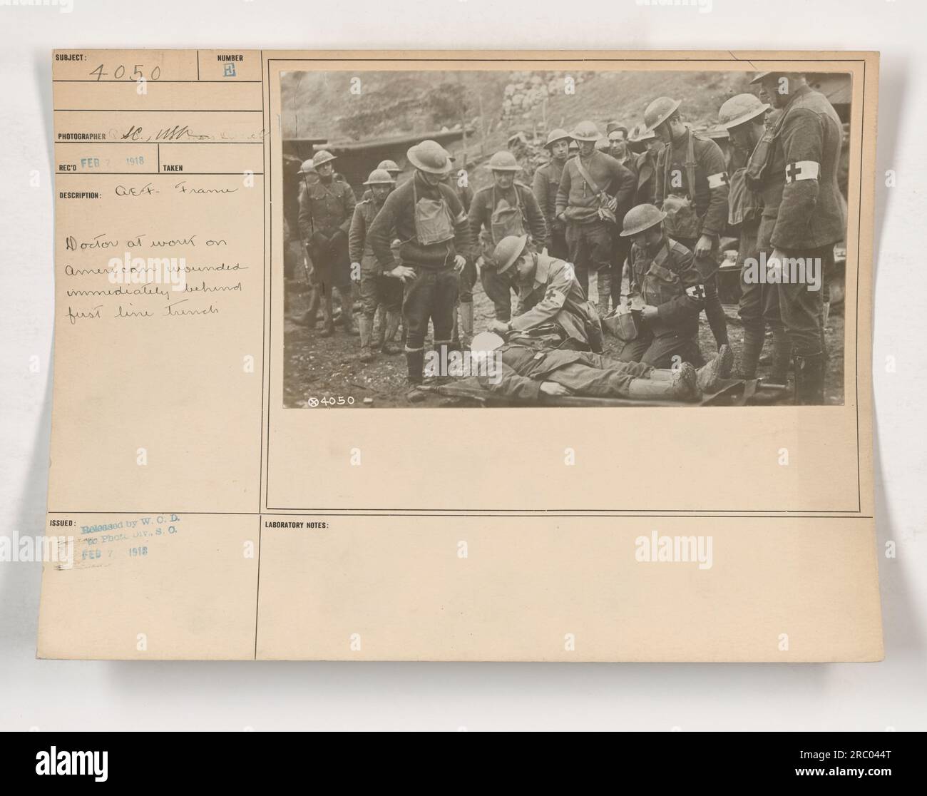 A doctor attending to wounded American soldiers behind the first line ...
