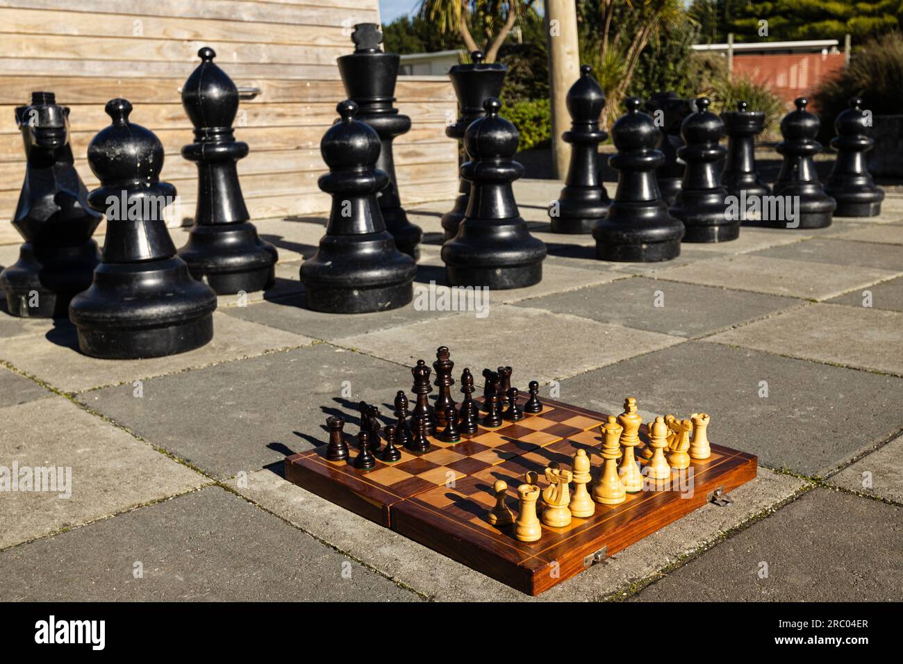 Chess set on a outside large chess area Stock Photo - Alamy
