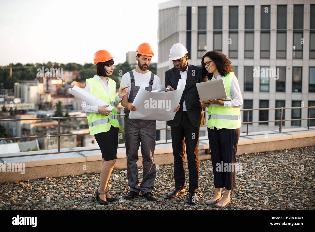 Team of multiracial architects and designers standing on panoramic ...