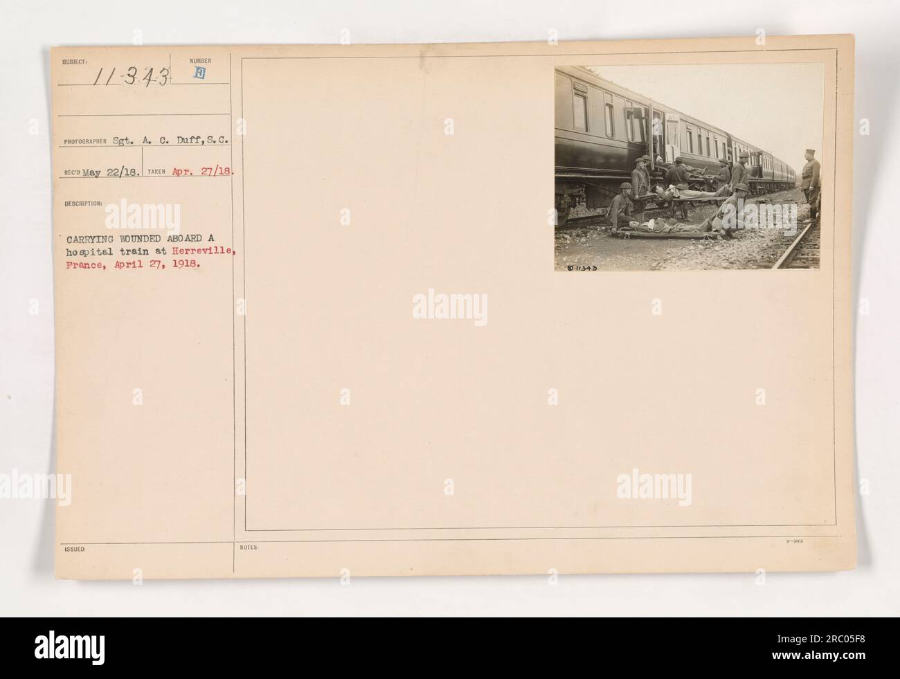 Sgt. A. C. Duff seen carrying wounded soldiers aboard a hospital train ...