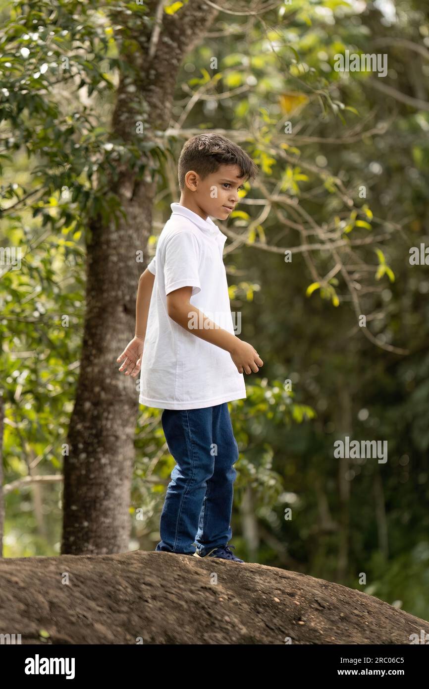 boy in blue jeans and white t-shirt having fun outdoors Stock Photo - Alamy