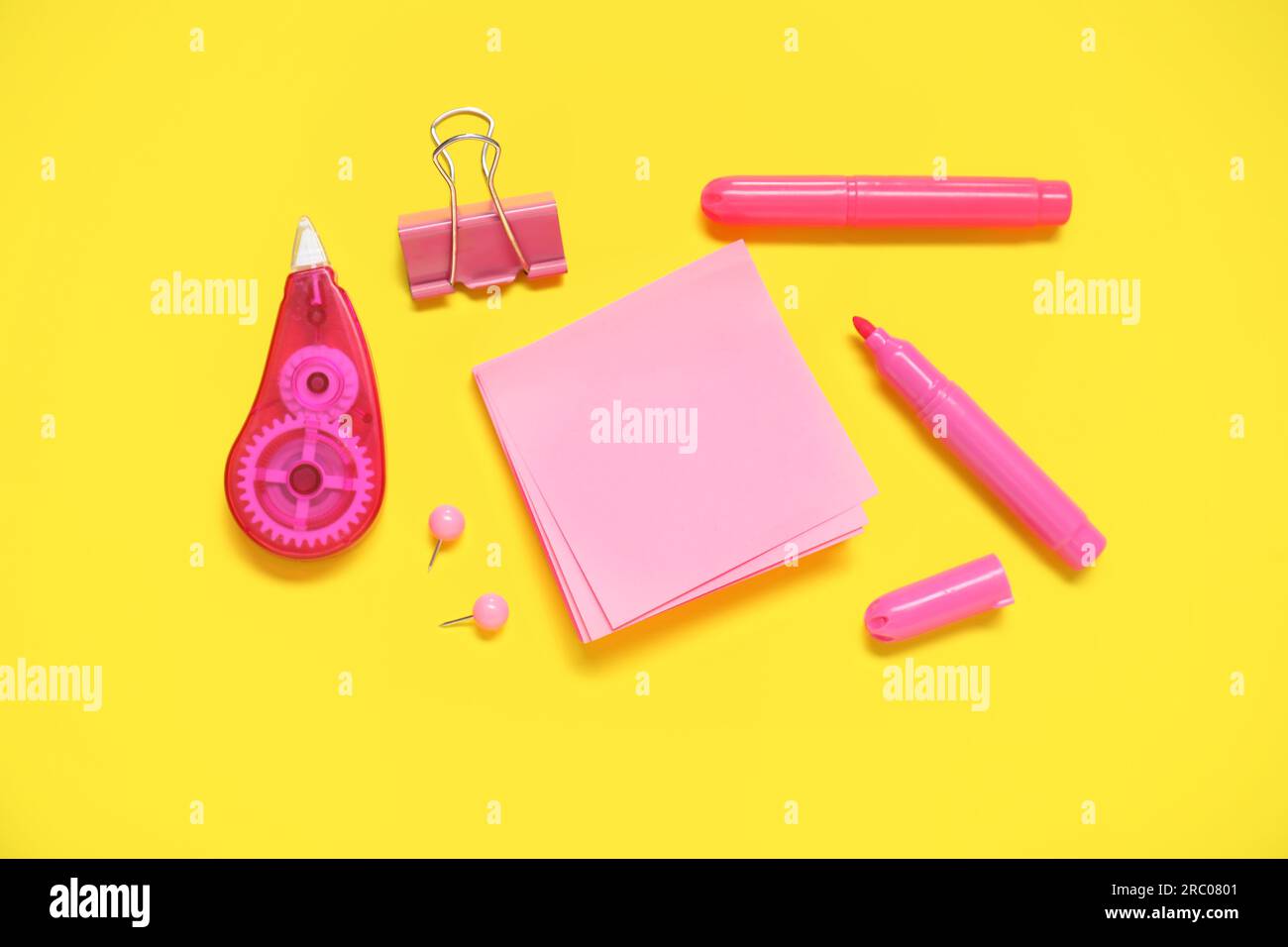 Sticky notes with different stationery supplies on yellow background ...