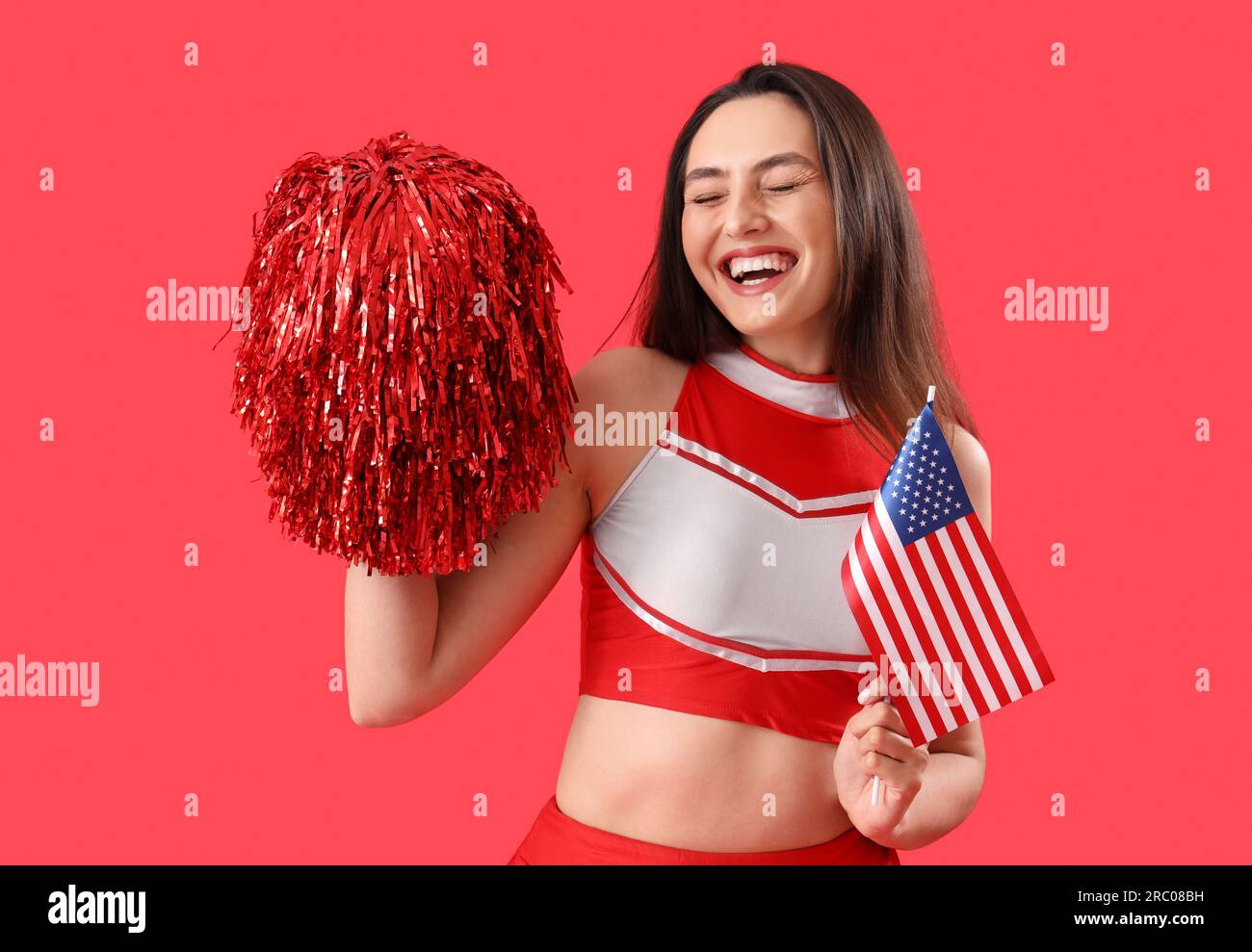 Female cheerleader with USA flag on red background Stock Photo - Alamy