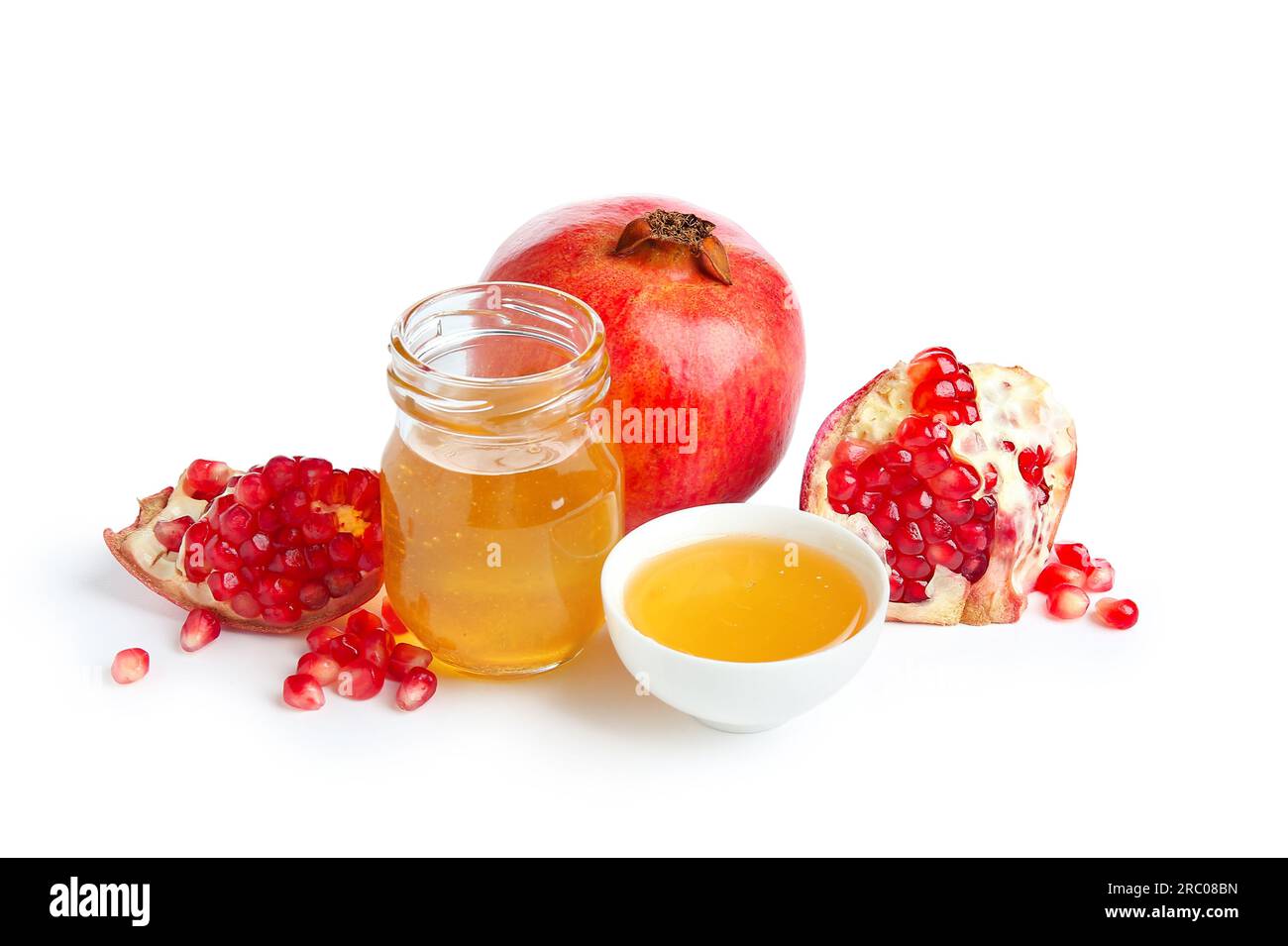 Sweet honey and pomegranates on white background. Rosh hashanah (Jewish ...