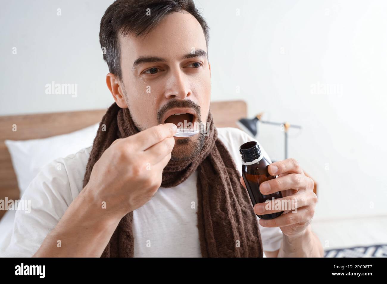 Man taking cough syrup hi-res stock photography and images - Alamy