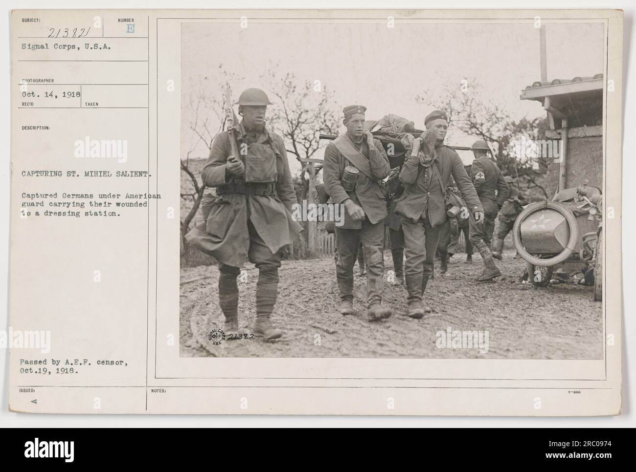 American soldiers escorting captured German soldiers carrying wounded ...