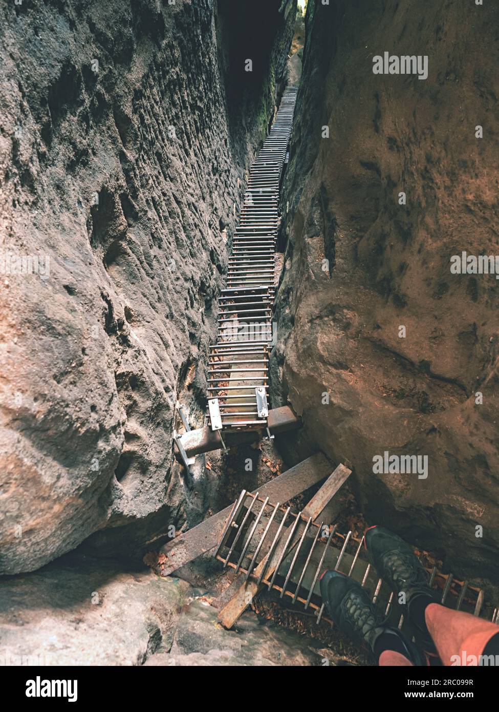 Steel path like steps and ladder in thin gulch between sandstone rocks ...