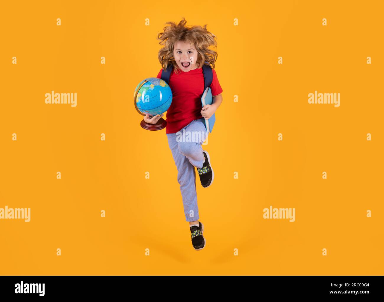 Back to school. Photo of excited little school jumping holding book ...