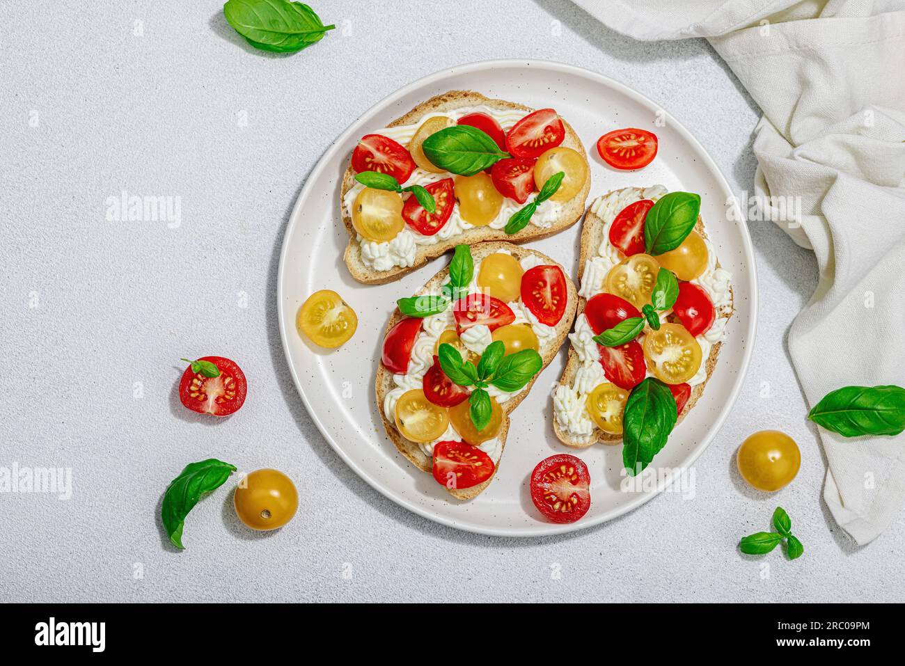 Fresh bread sandwiches with tomato cherry, cream cheese and basil ...