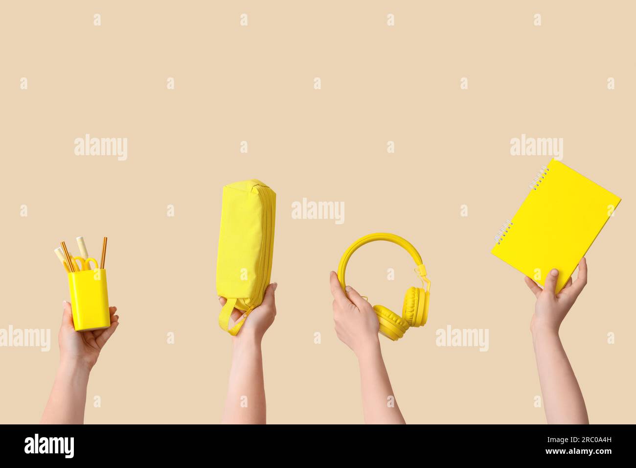 Female hands holding school supplies on beige background Stock Photo ...