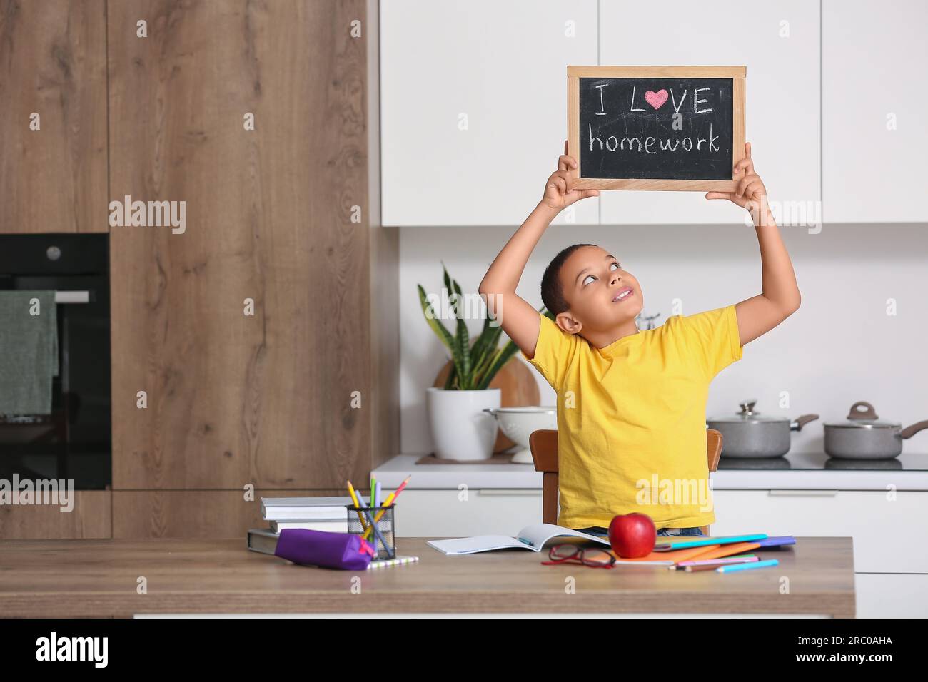 Little African-American boy holding chalkboard with text I LOVE ...