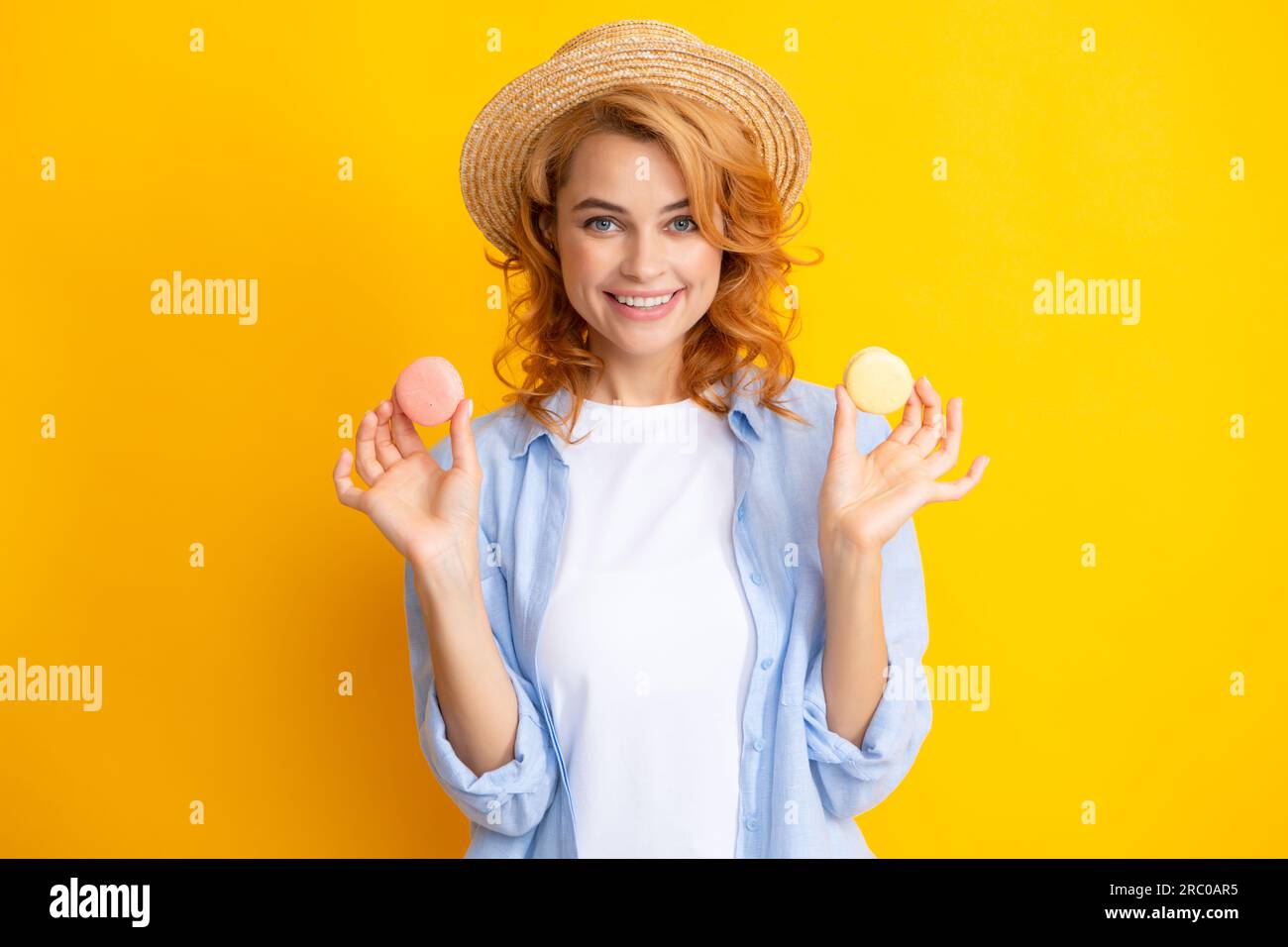 Beauty model girl taking colorful macaroons. Beautiful woman eating ...