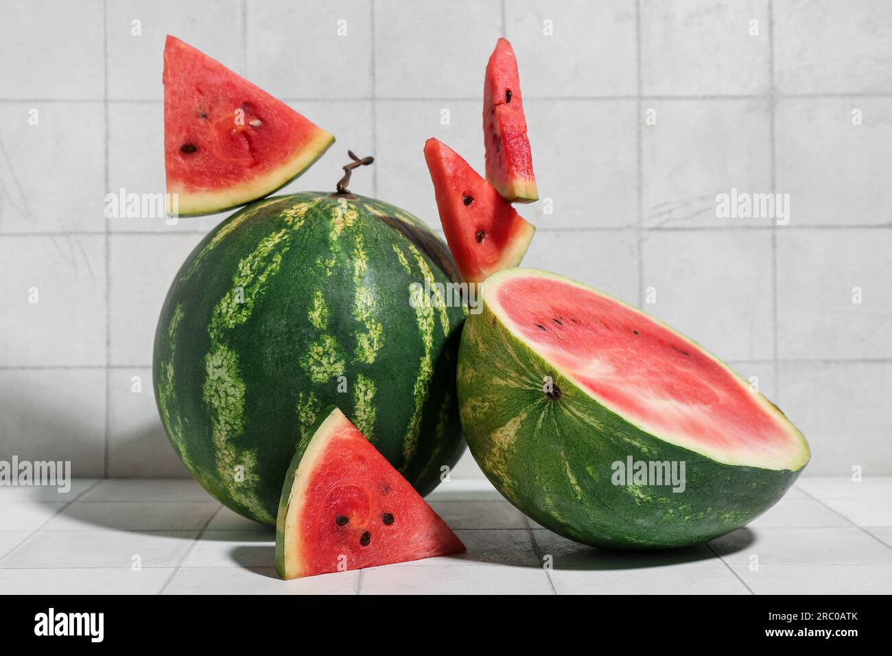 Fresh watermelons on white tile background Stock Photo - Alamy