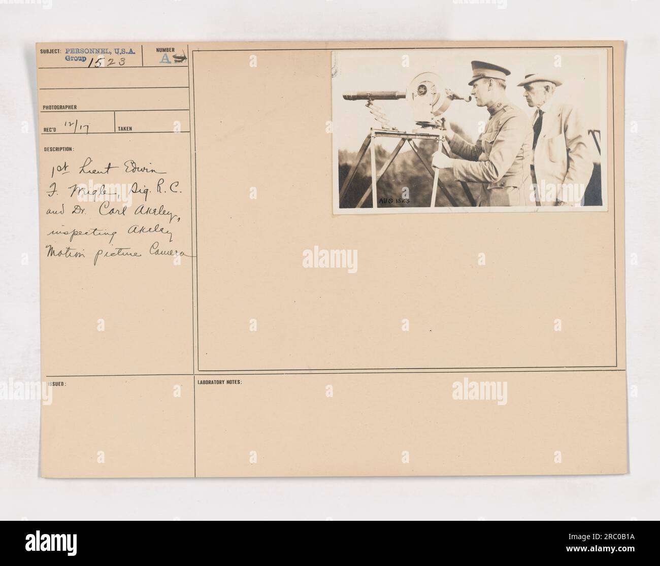 1st Lt. Edwin F. Weigle, S.R.C., and Dr. Carl Akeley inspect an Akeley ...