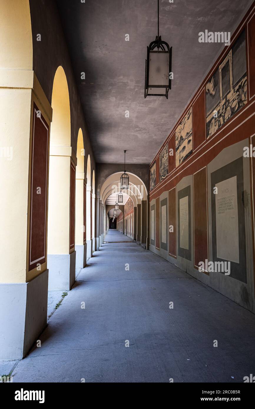 Promenade with long arcade columns surrounding Hofgarten Park in Munich ...