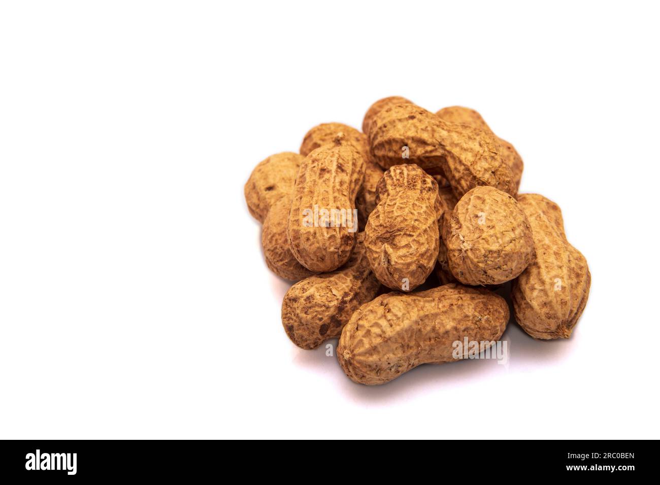 Pile of peanuts on white isolated background in close-up Stock Photo ...