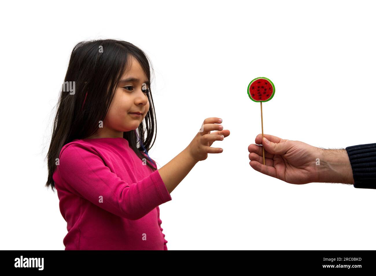 The little girl takes the candy offered to her Stock Photo - Alamy