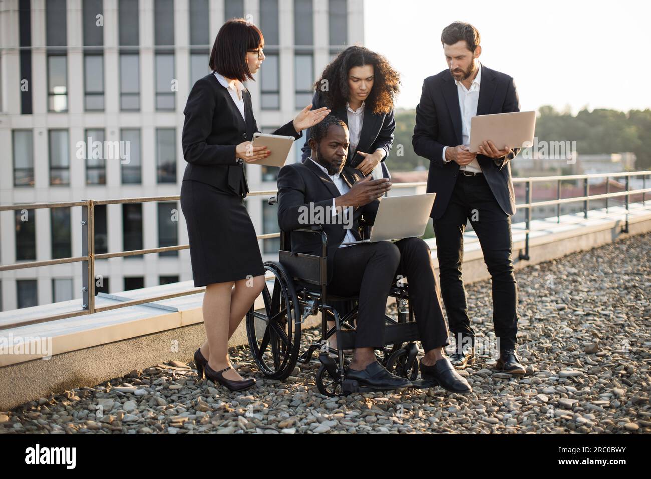 African american businessman with disability holding computer on knees ...