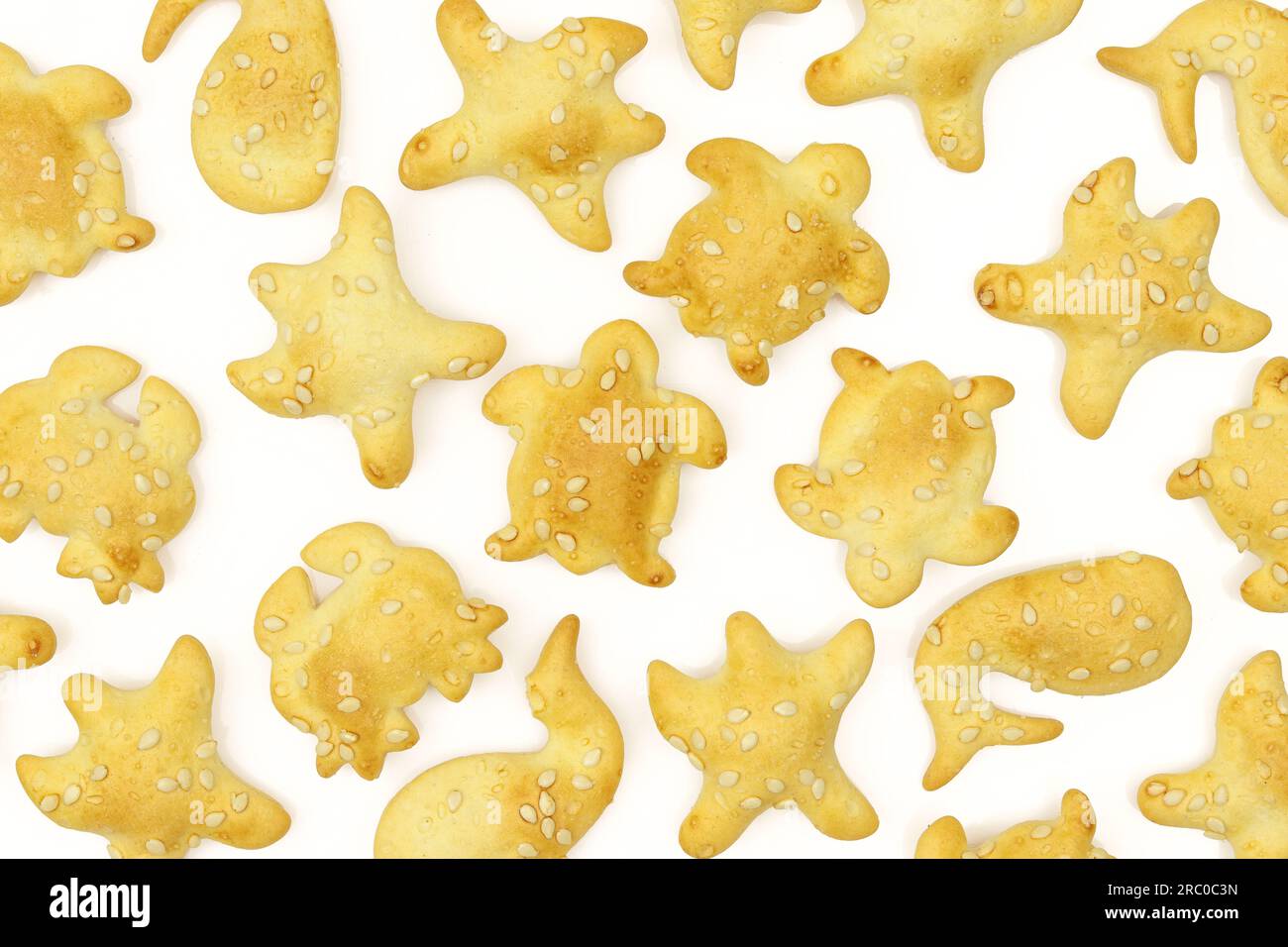 Background pattern of sesame sprinkled sea creatures shaped crackers ...