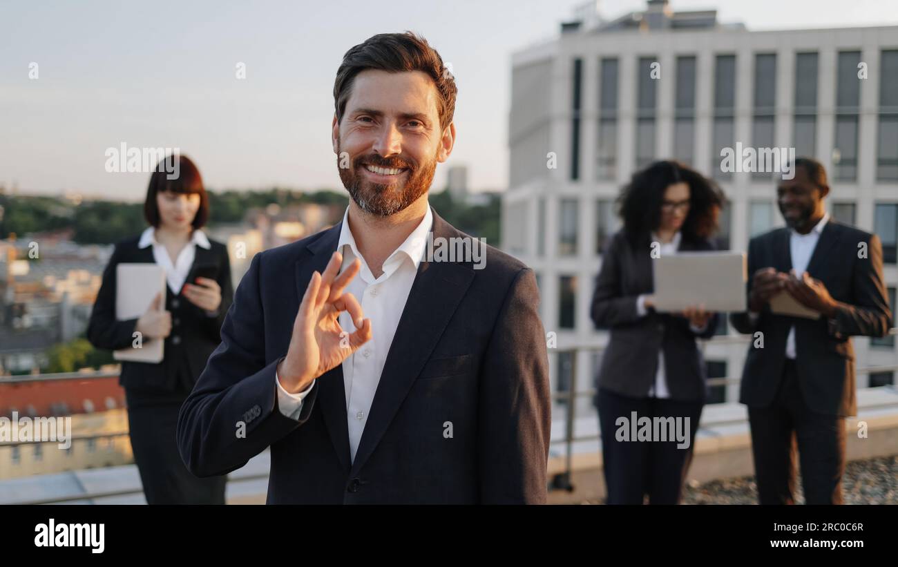 Portrait of confident bearded executive in business attire posing on ...