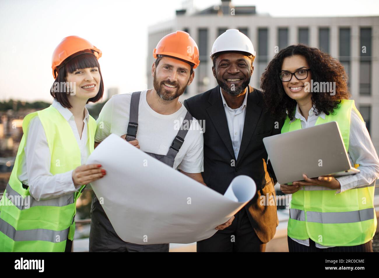 Portrait of multicultural group of developers posing on camera with ...