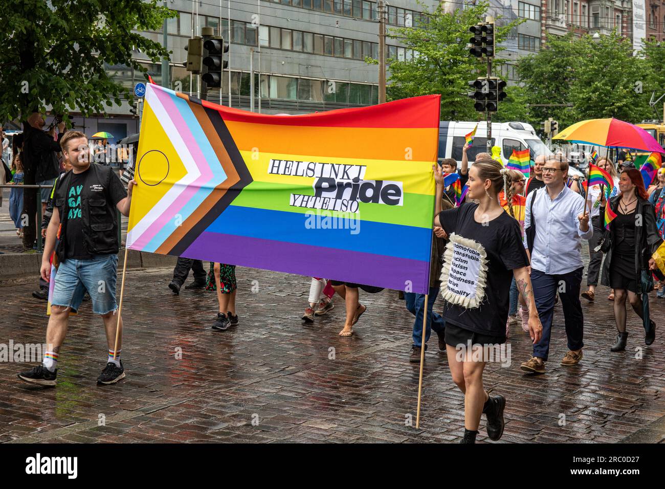 People marching and carrying Helsinki Pride Yhteisö banner at Helsinki ...