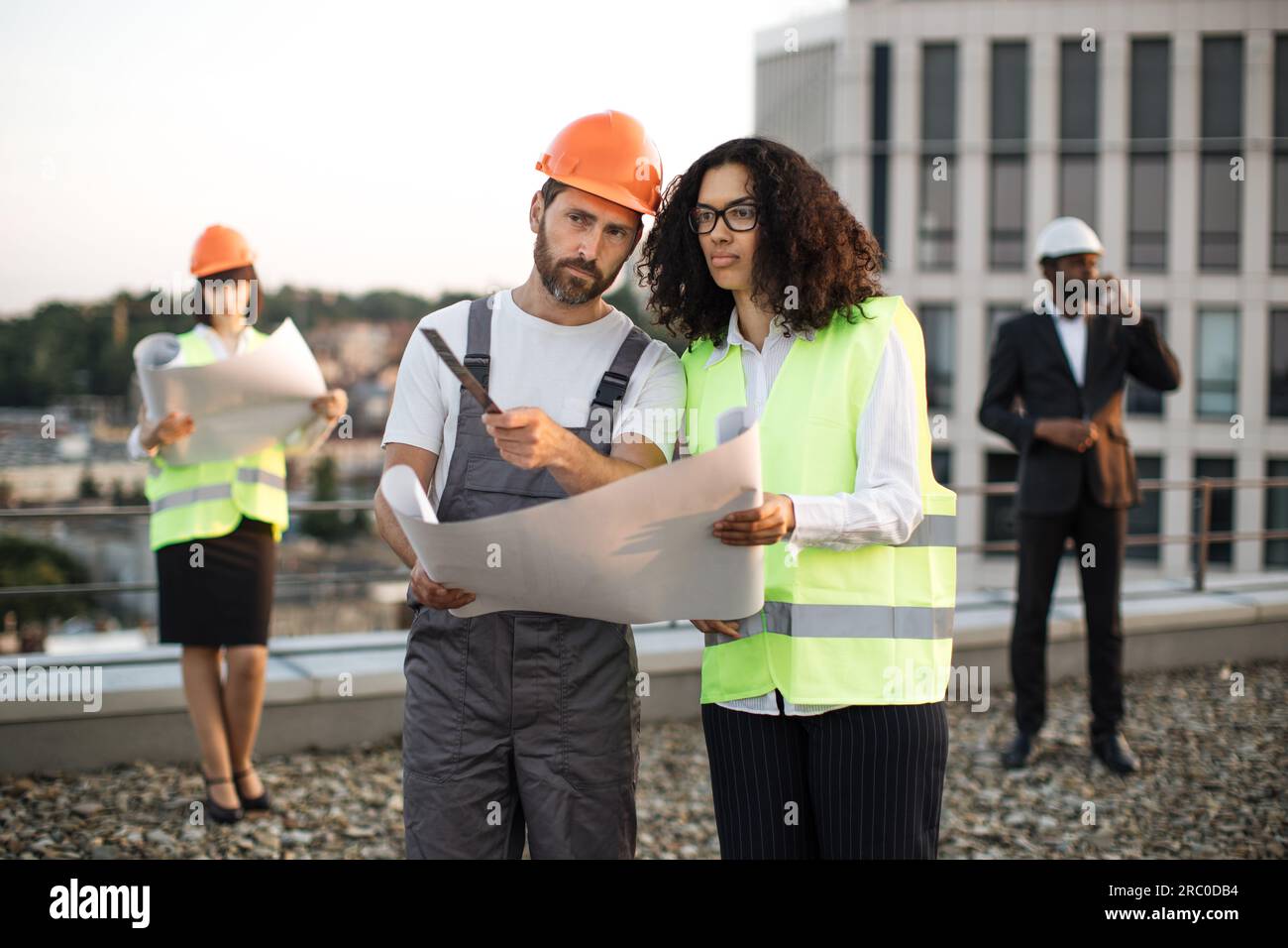 Foreman with ruler in hands talking to inspector and explaining ...