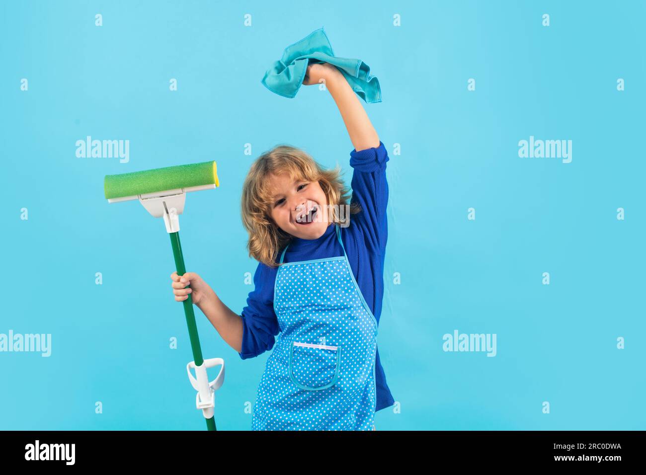 Child doing housework. Studio portrait of child helping with housework ...