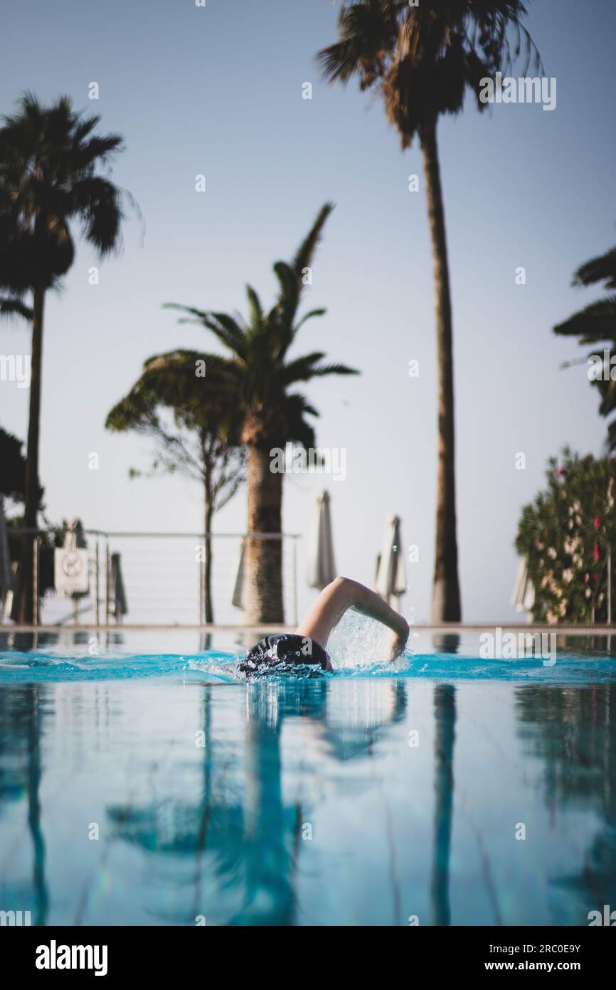 Person doing crawl stroke in swimming pool Stock Photo - Alamy