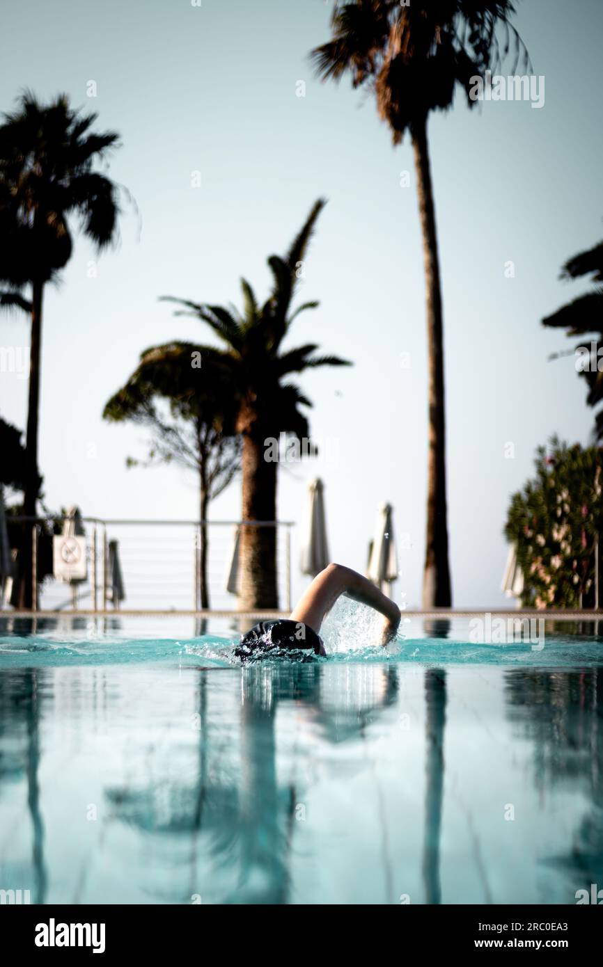 Person doing crawl stroke in swimming pool Stock Photo - Alamy