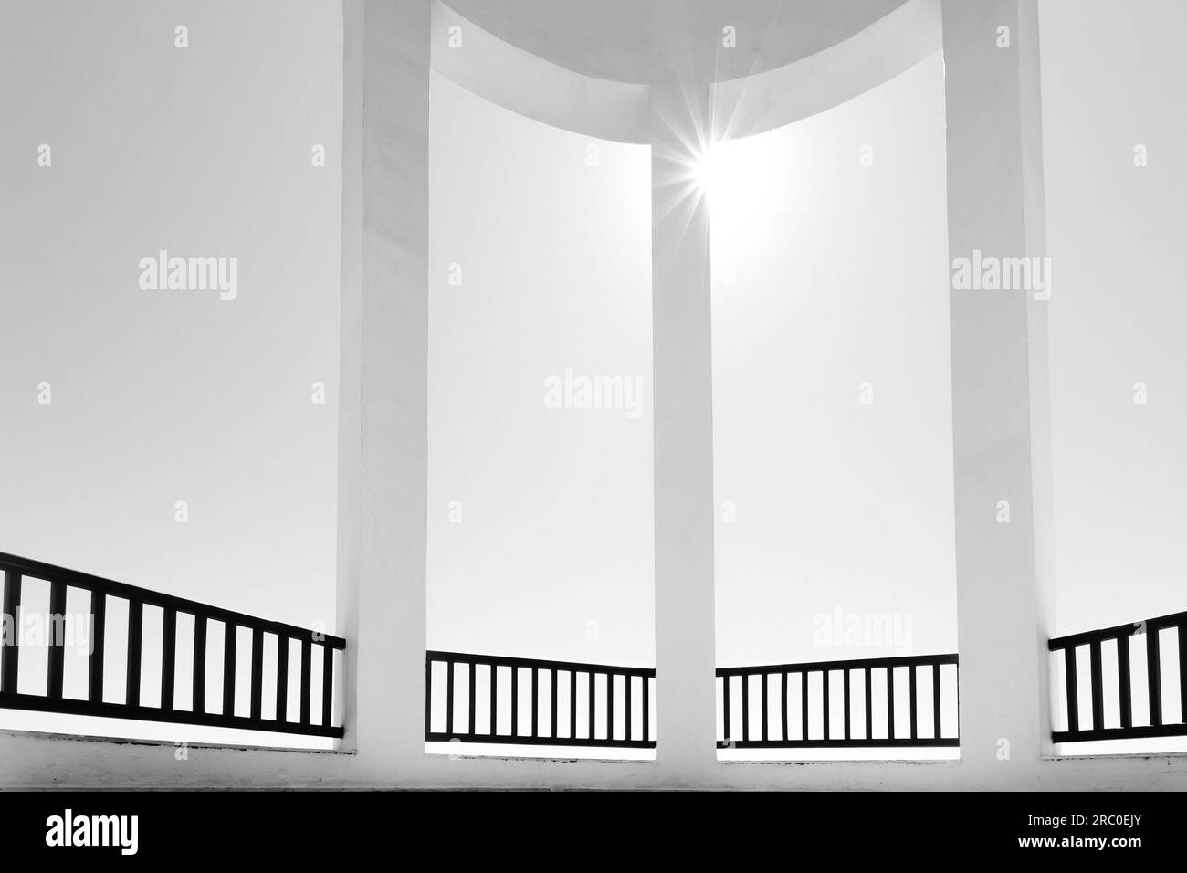 View to blue sky with the sun in shape of a star through architectural ...