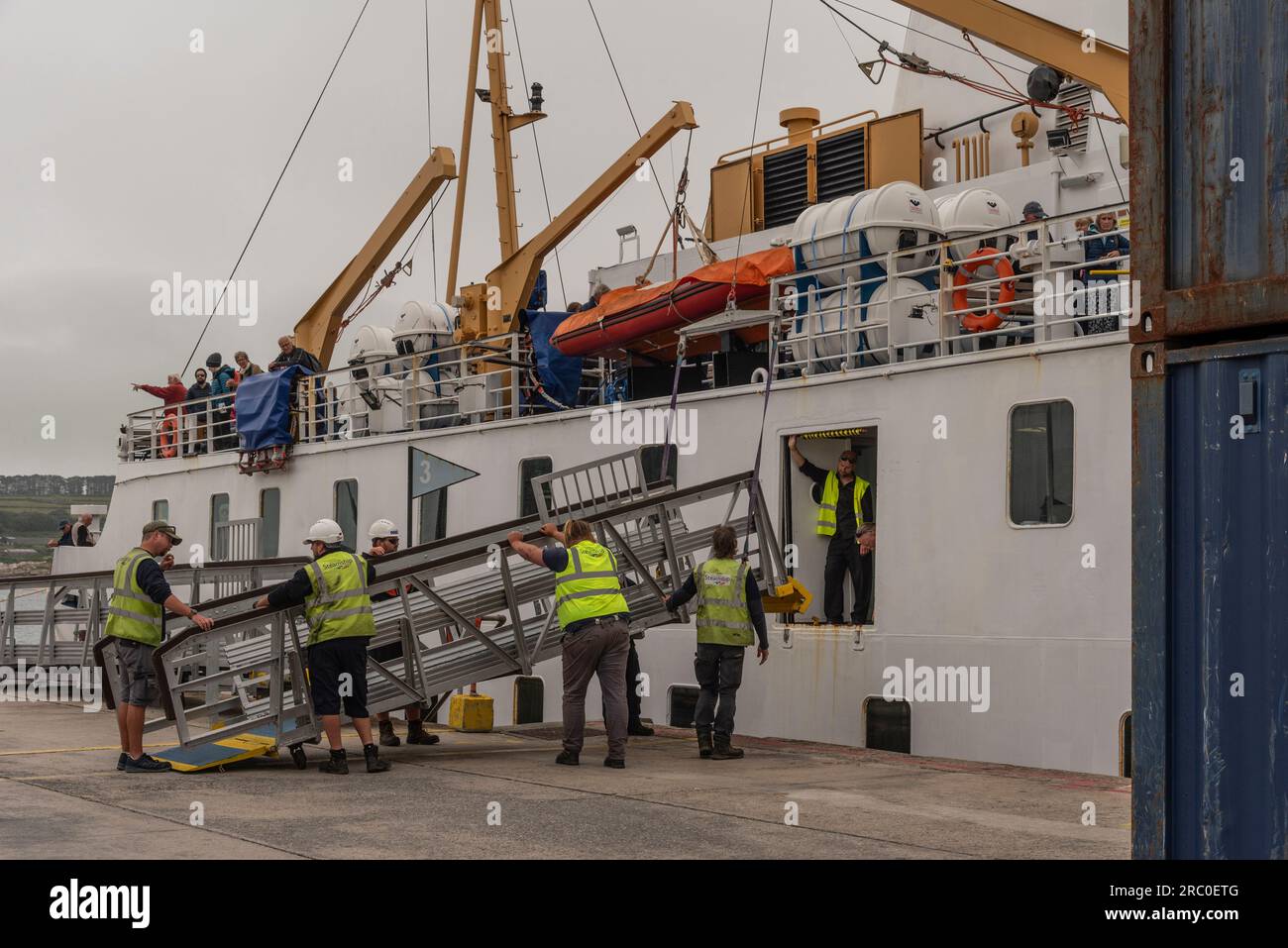 St Marys Quay, Scilly Isles, England,UK. 10 June 2023. Crew and deck hands manhandle the ...