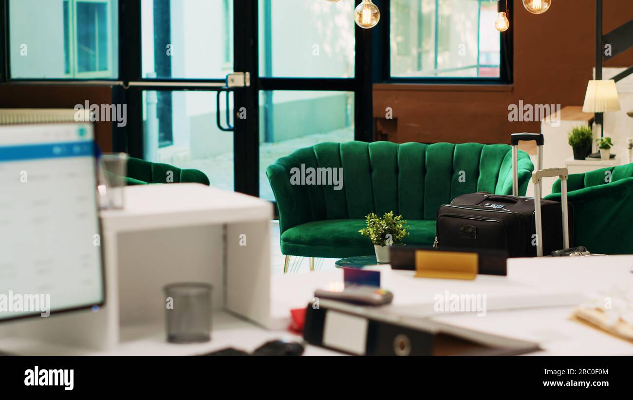 Empty hotel lobby with lounge area and reception desk used to help ...