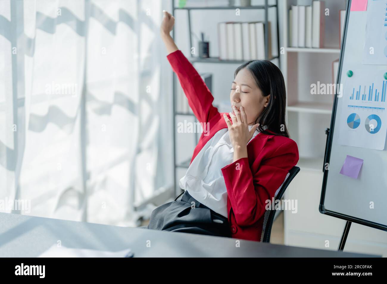 Rear view young businesswoman leaning back in comfortable chair ...