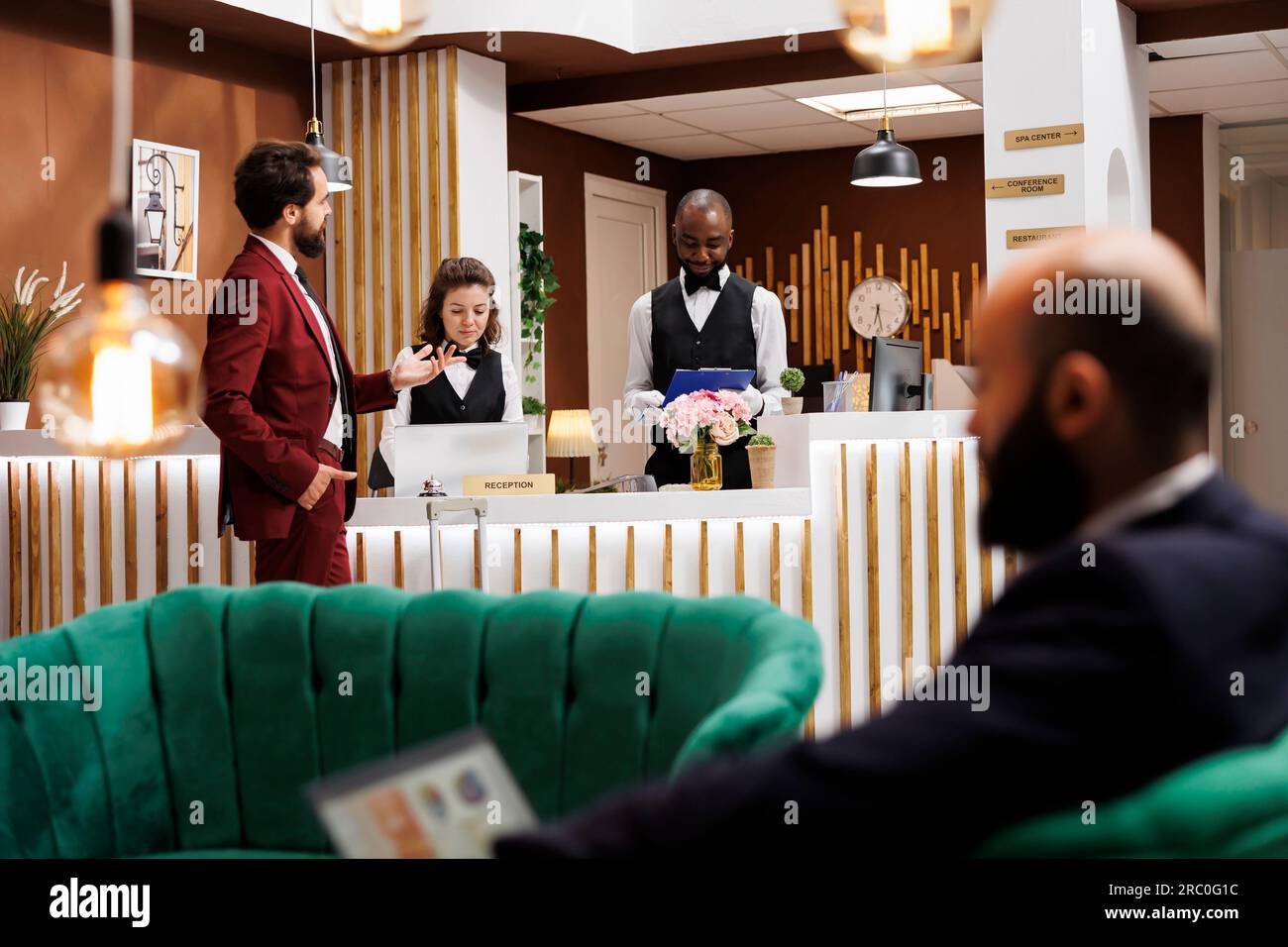 Guest asking hotel staff about services, ensuring pleasant stay and ...