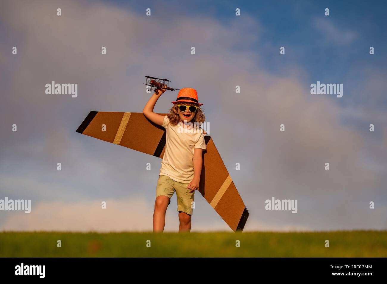 Boy kid dreams of becoming a pilot. Kid playing with toy airplane and ...