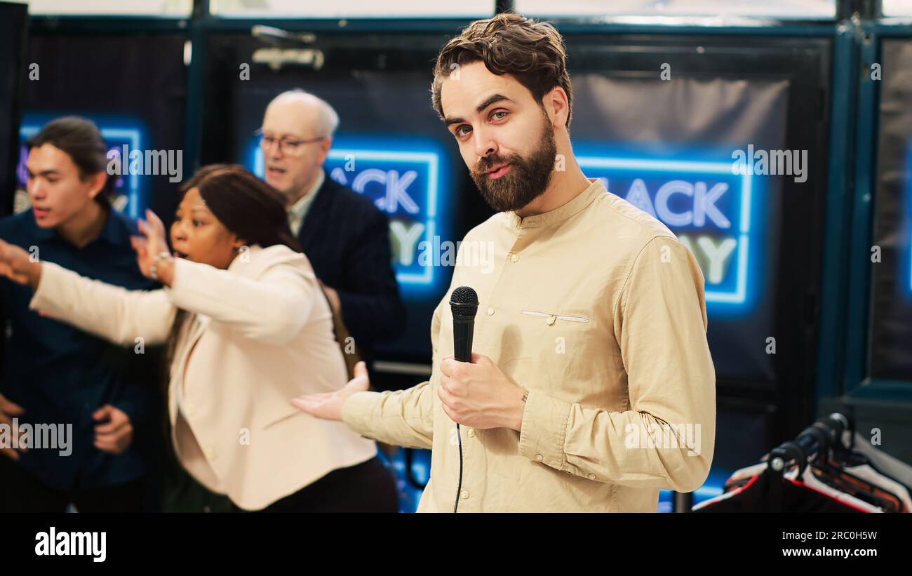 News reporter in crowded clothing store holding microphone and ...