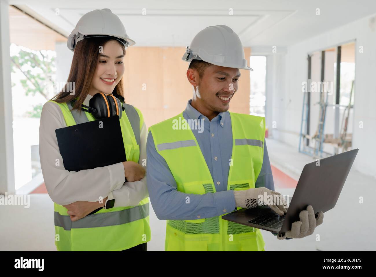 multi ethnic engineer brainstorming and measuring for cost estimating ...