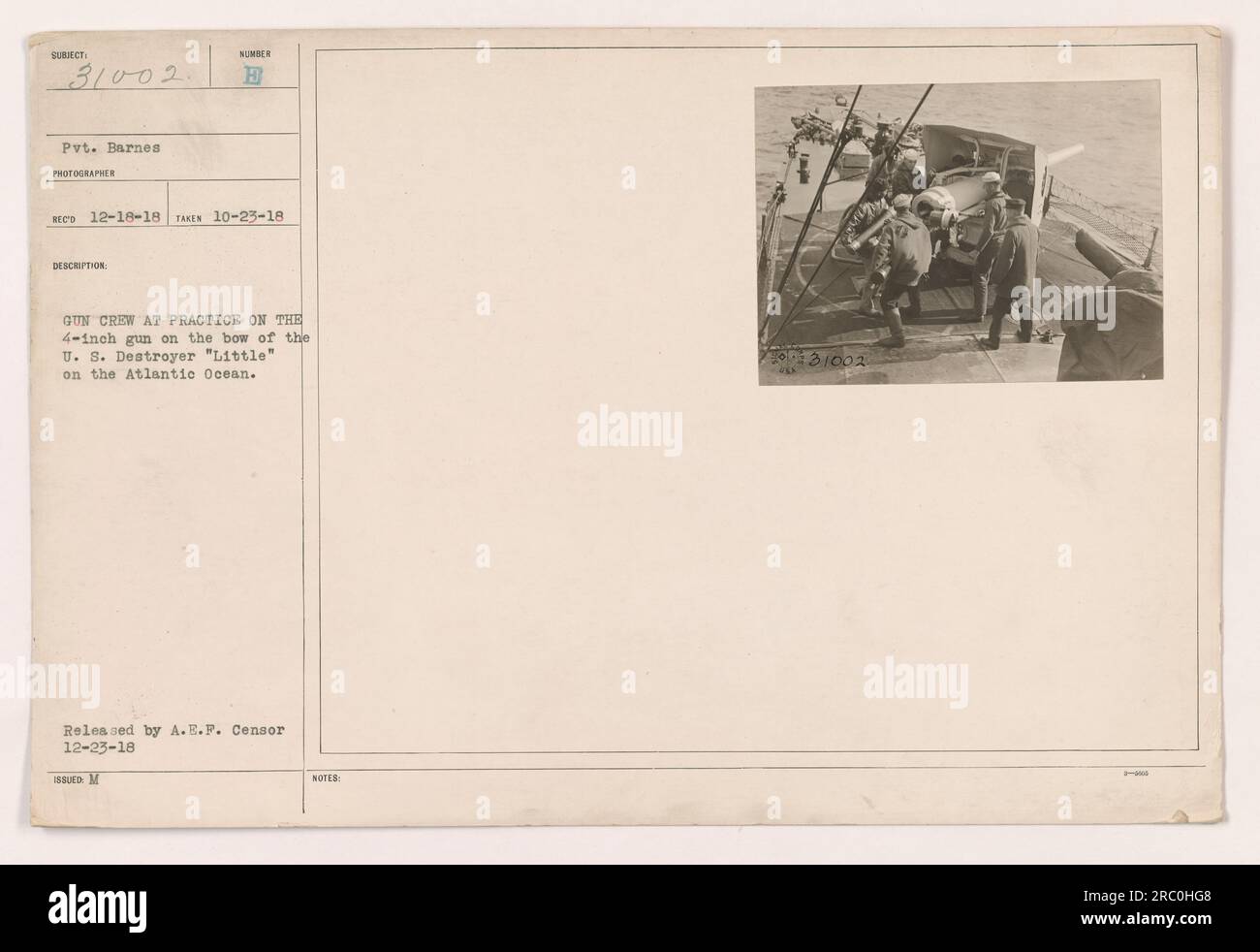Gun crew practicing on a 4-inch gun on the bow of the U.S. Destroyer ...