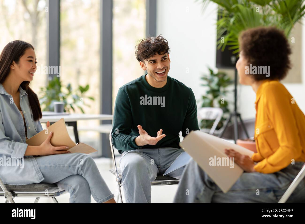 Teamwork concept. International students talking and discussing their ...