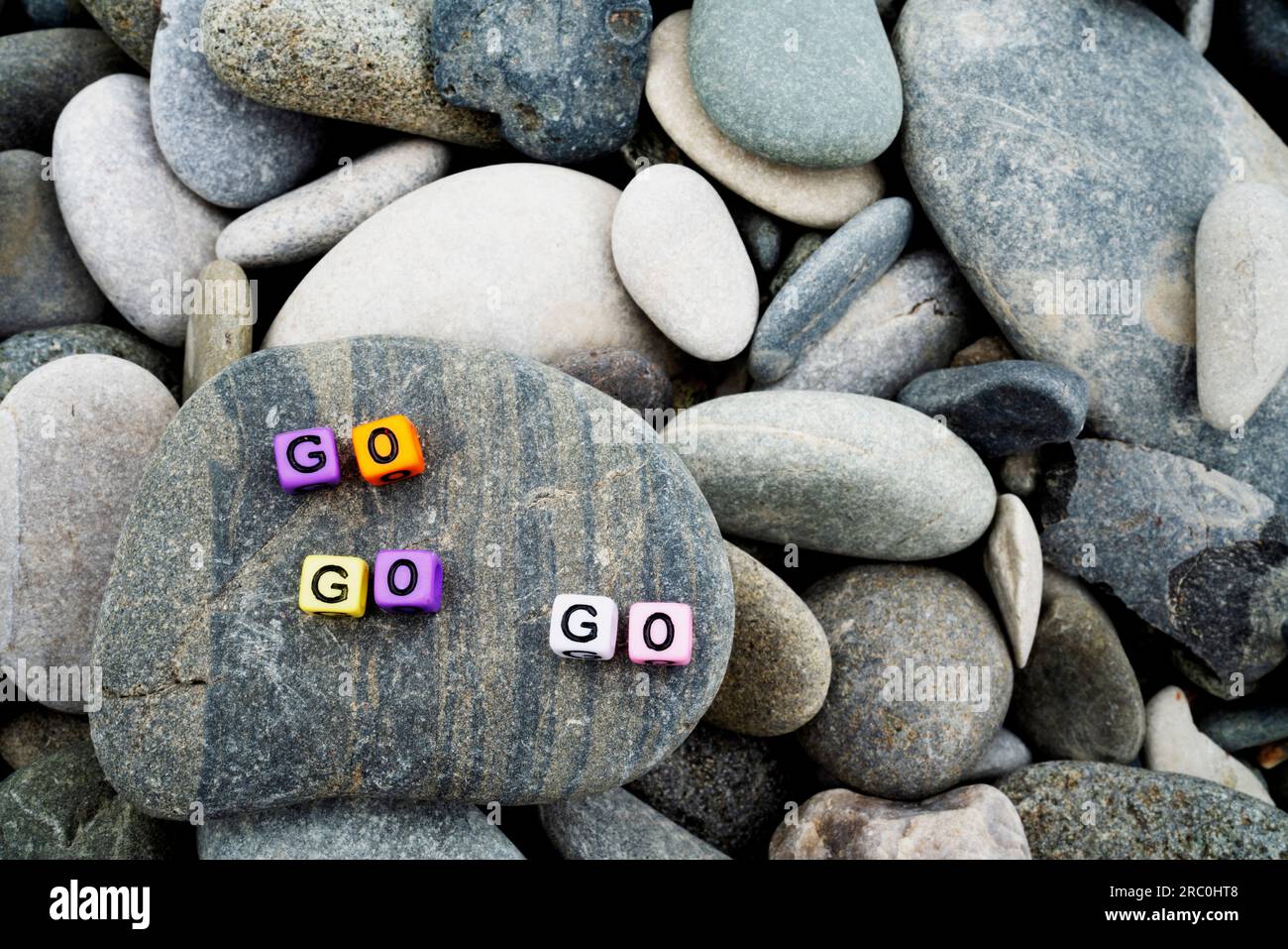 go word on pebble stone for background and inspiration or multiple ...