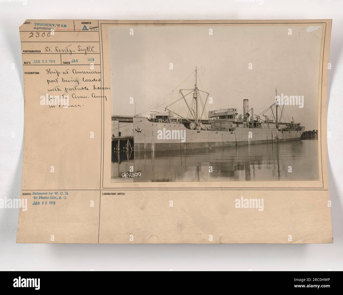 Ships at an American port loading portable houses for the American Army ...