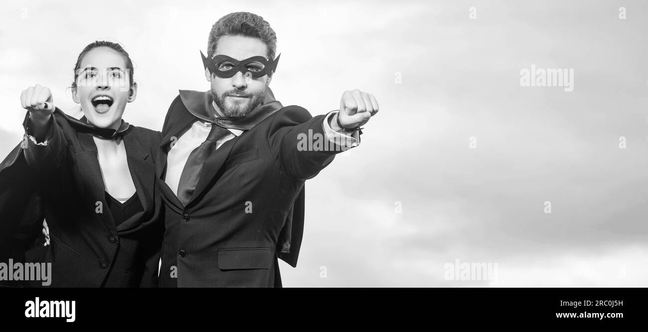 business couple in superhero suit on sky background. copy space ...