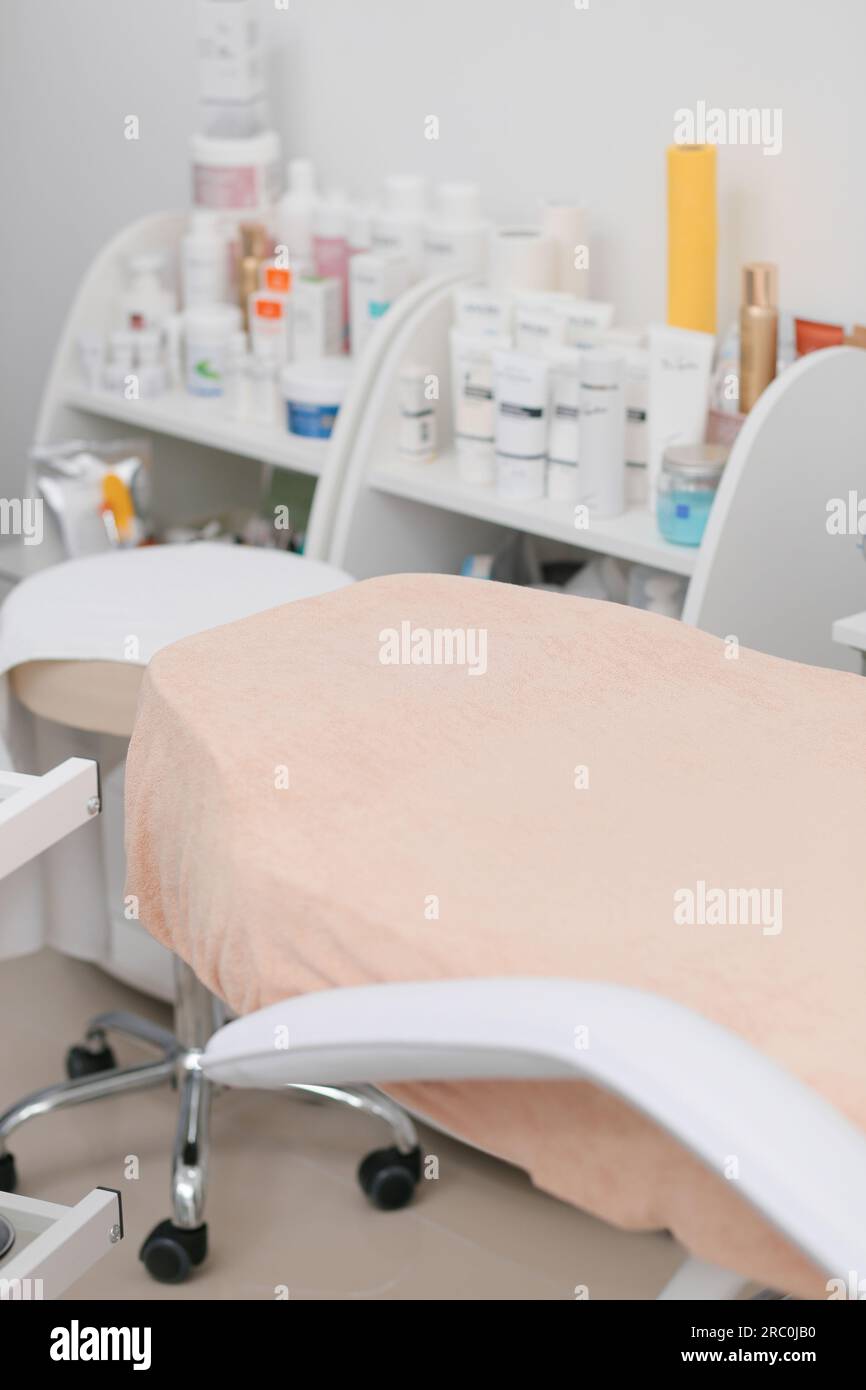 Modern beautician office with couch, face care cosmetics and body care ...