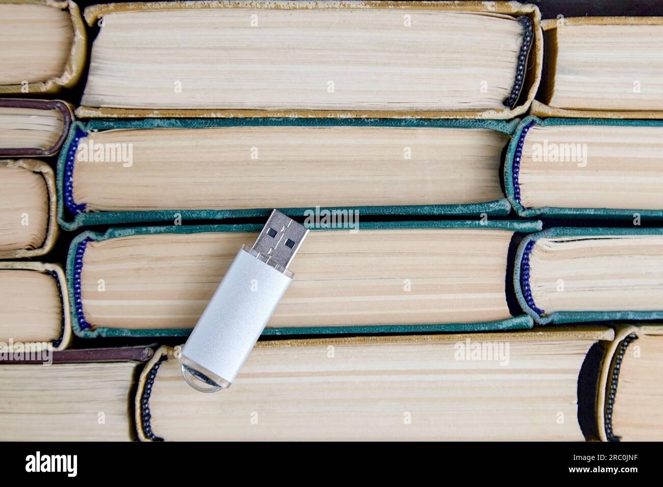 usb flash drive on background of stack of paper books. keepers of ...