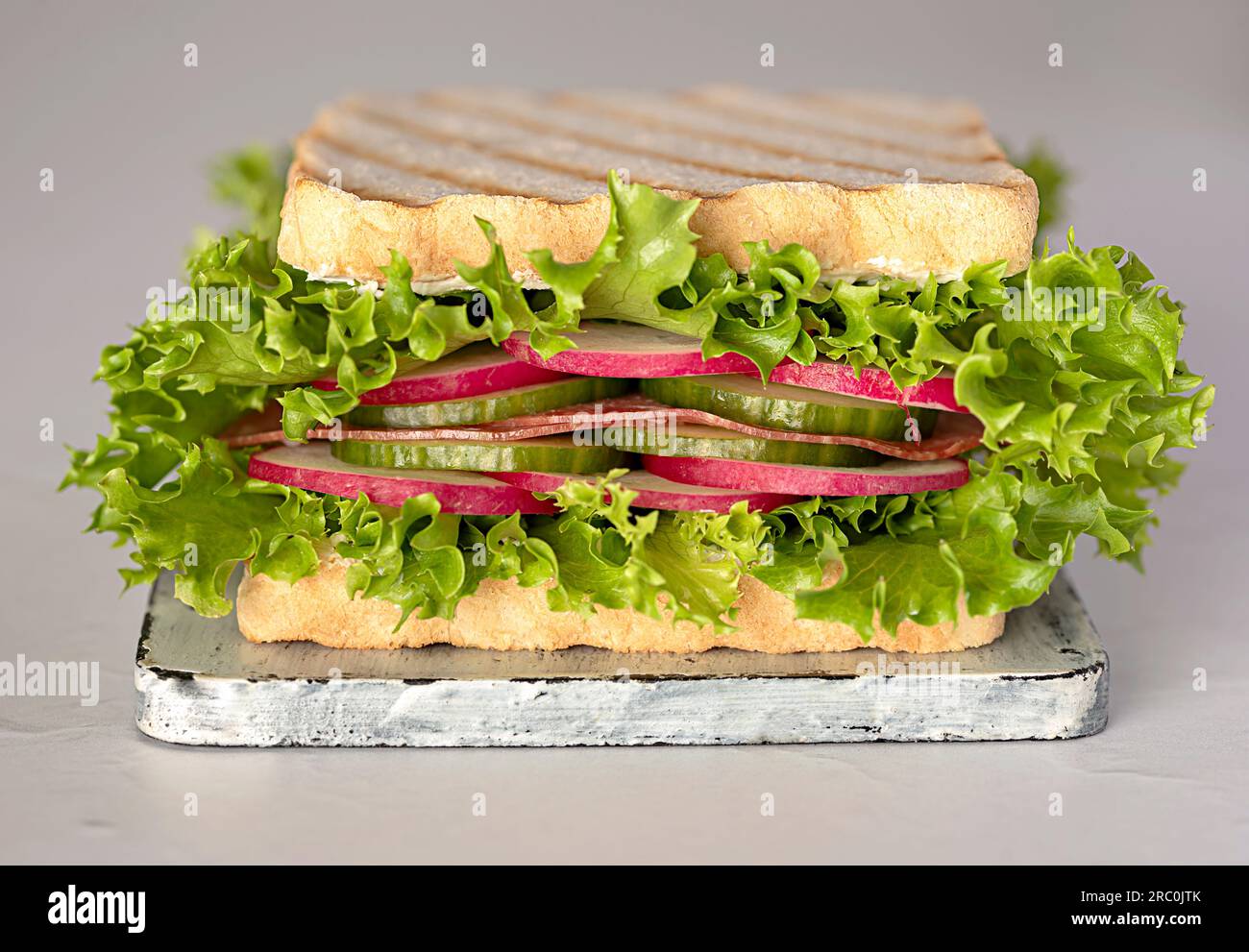 Macro food photography of sandwich, lettuce, toast, radish, salami ...