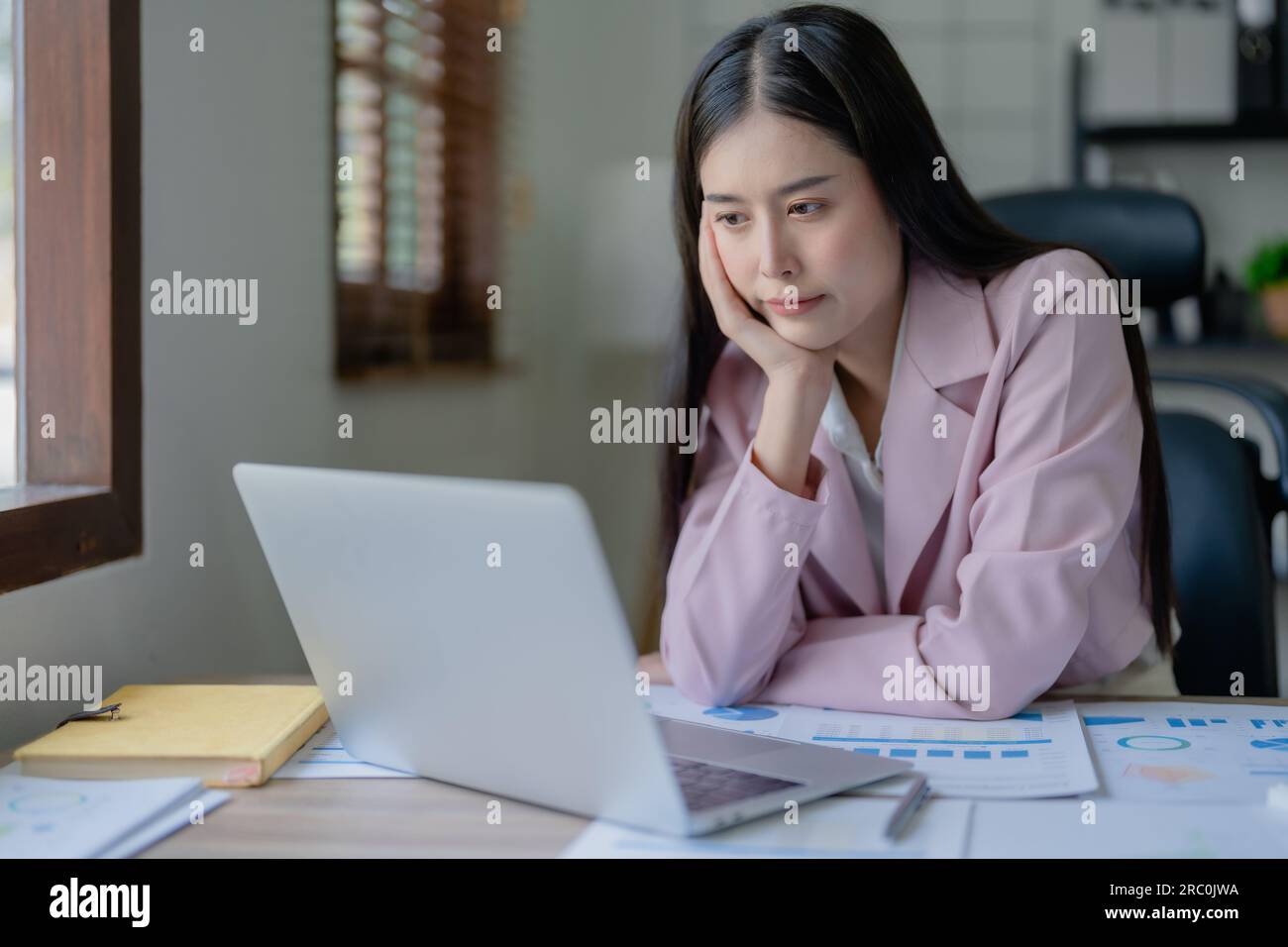 Portrait of a young Asian woman showing acute headache from sitting for ...
