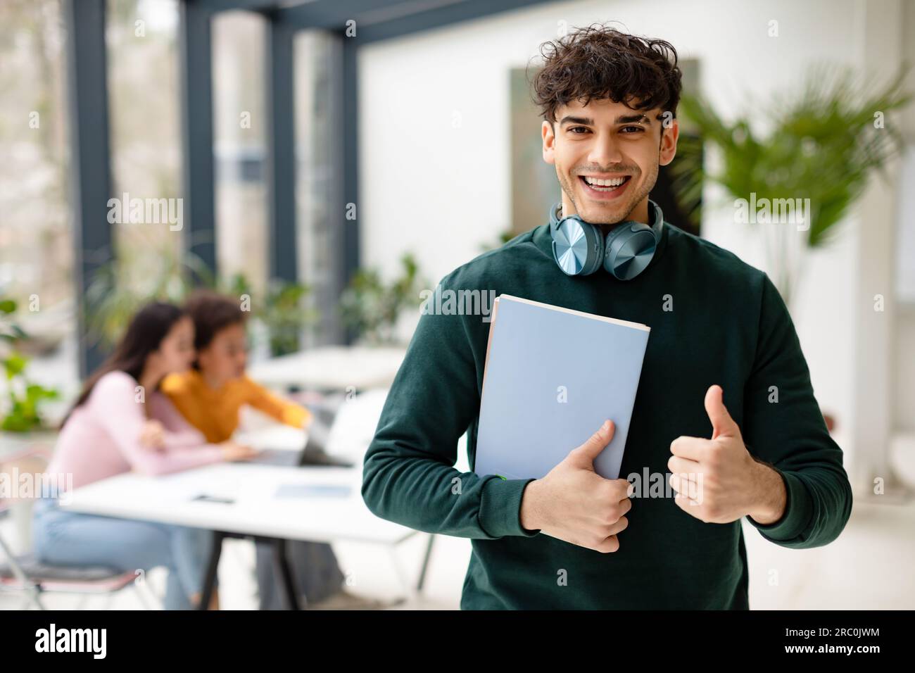 Academic success. Portrait of smiling european male student standing in ...