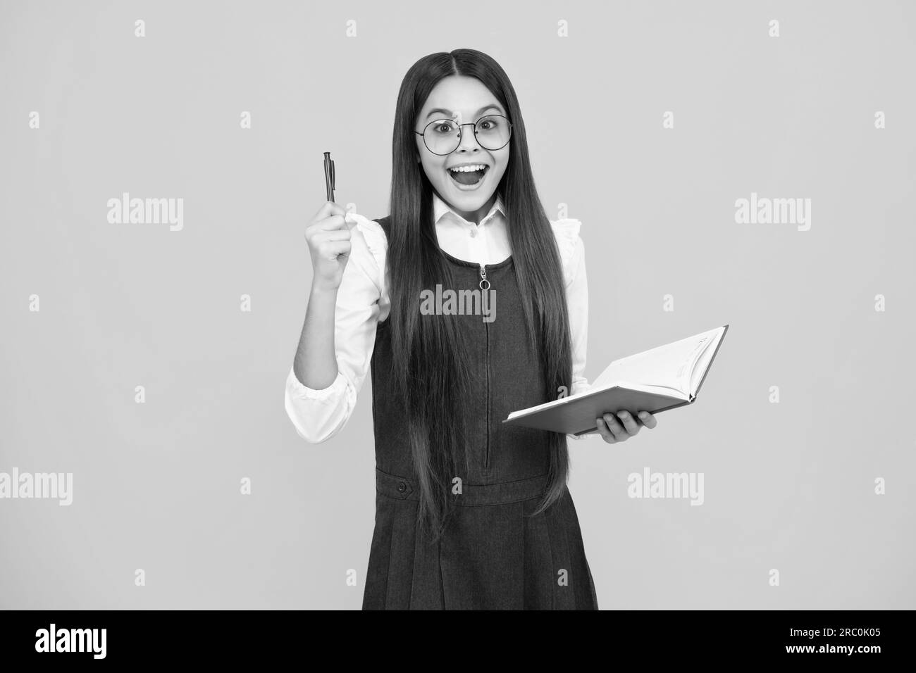 Teenager school girl with books isolated studio background. Surprised ...